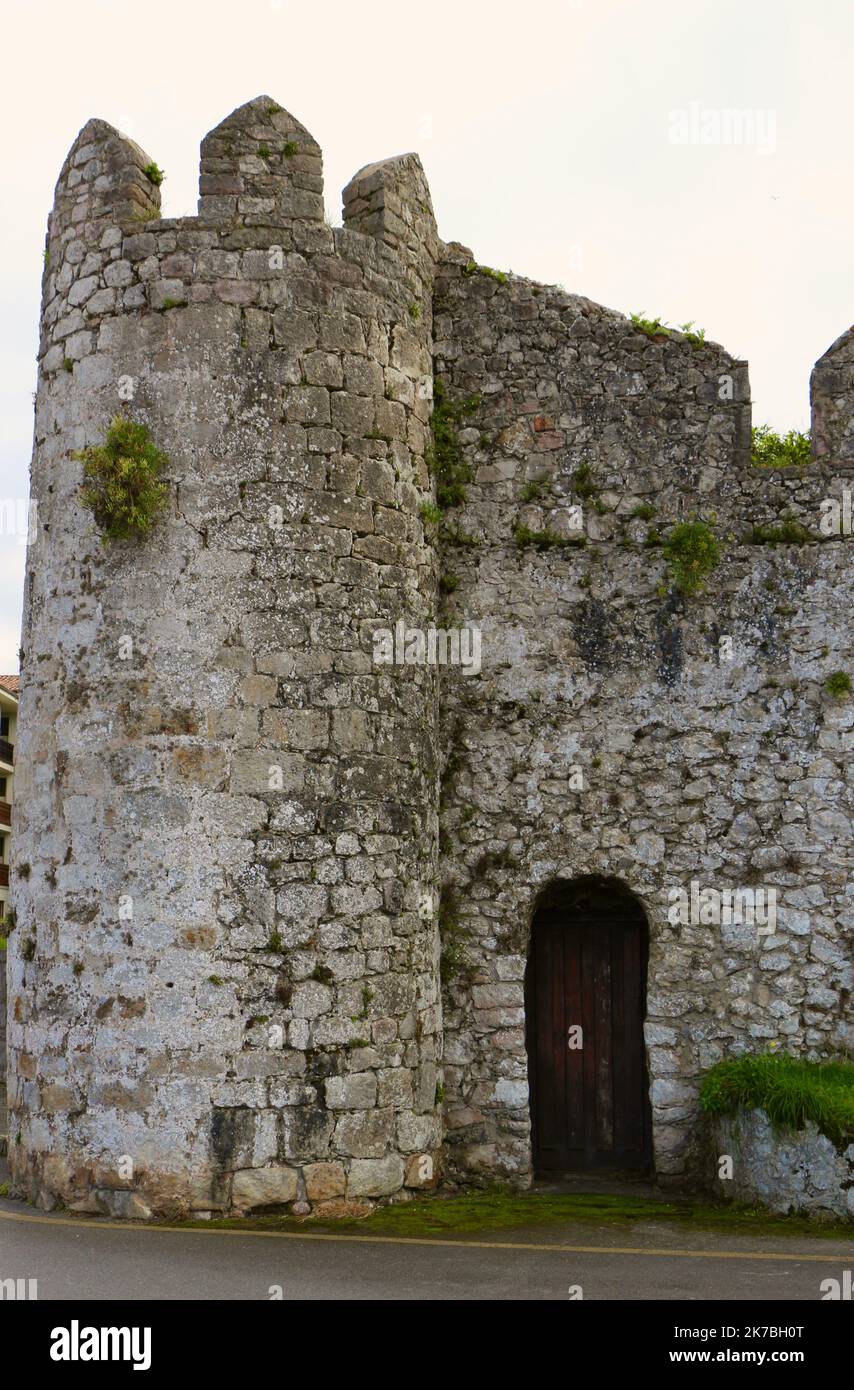 Medieval castellated stone wall tower and wooden door Llanes Asturias ...