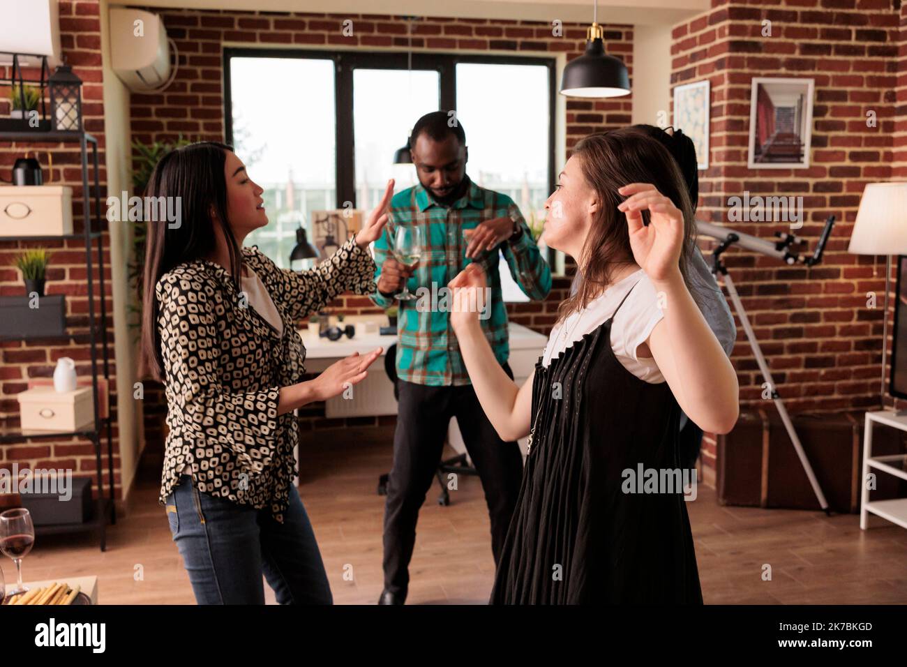 Multicultural friends, mates, partners drinking wine, having fun ...