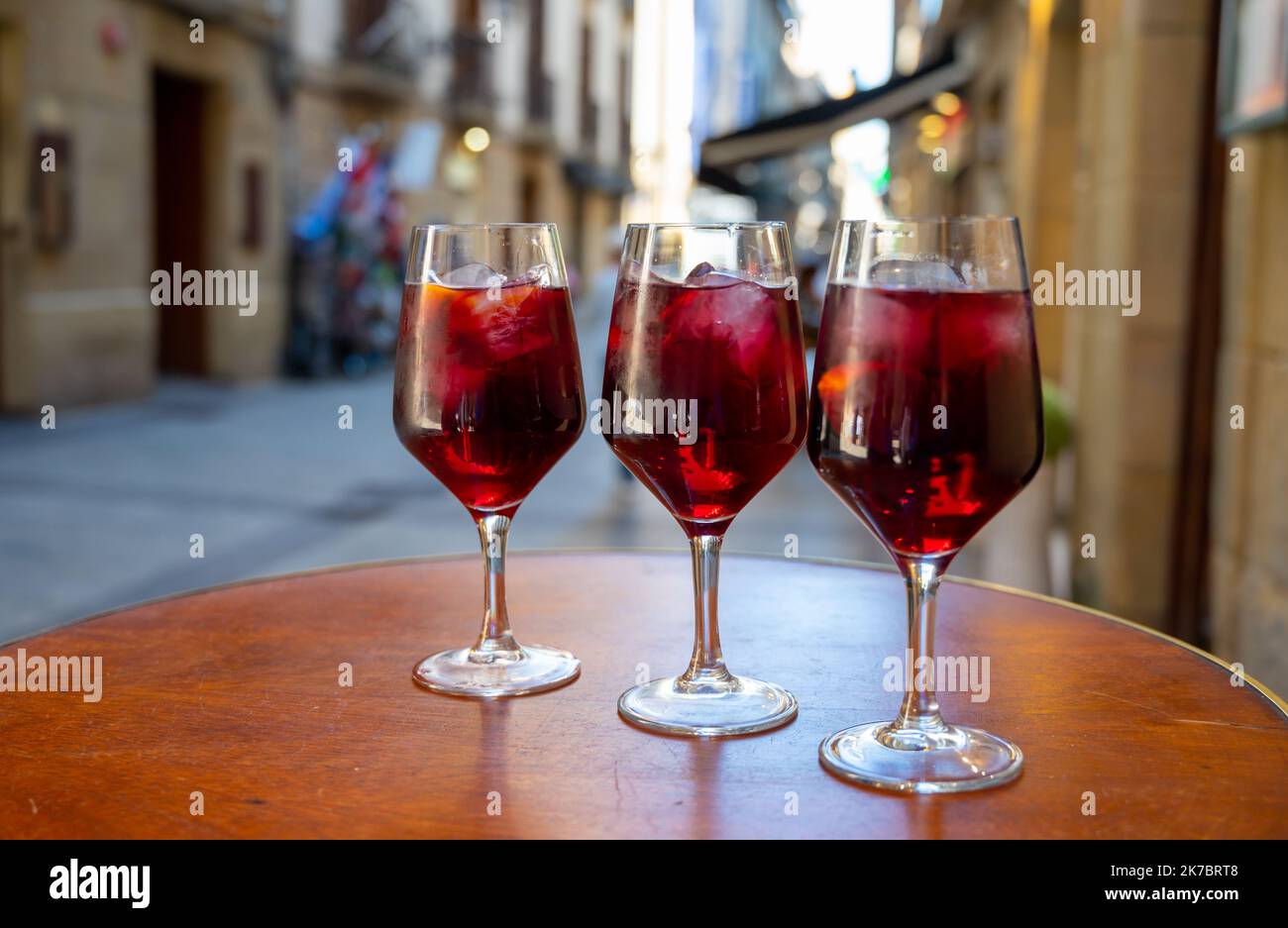Glasses of cold sangria wine served outdoor in bar with view on old ...