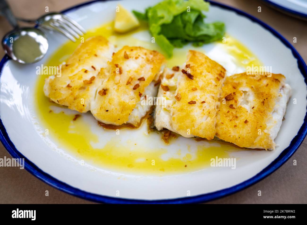 Grilled fillet of white codfish served in fish restaurant in San Sebastian, Basque Country ...