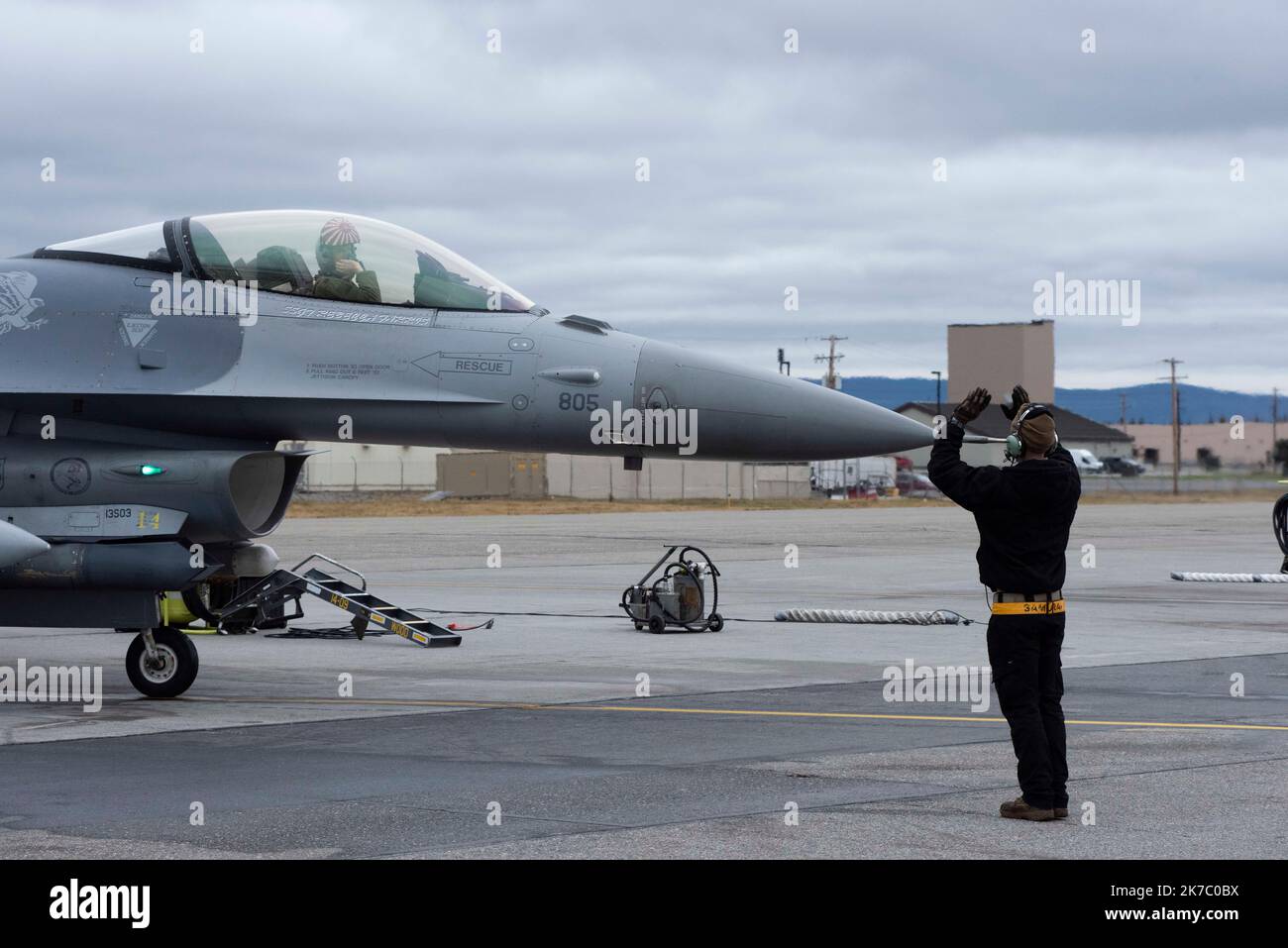 A U.S. Air Force crew chief with the 35th Fighter Wing signals a pilot ...