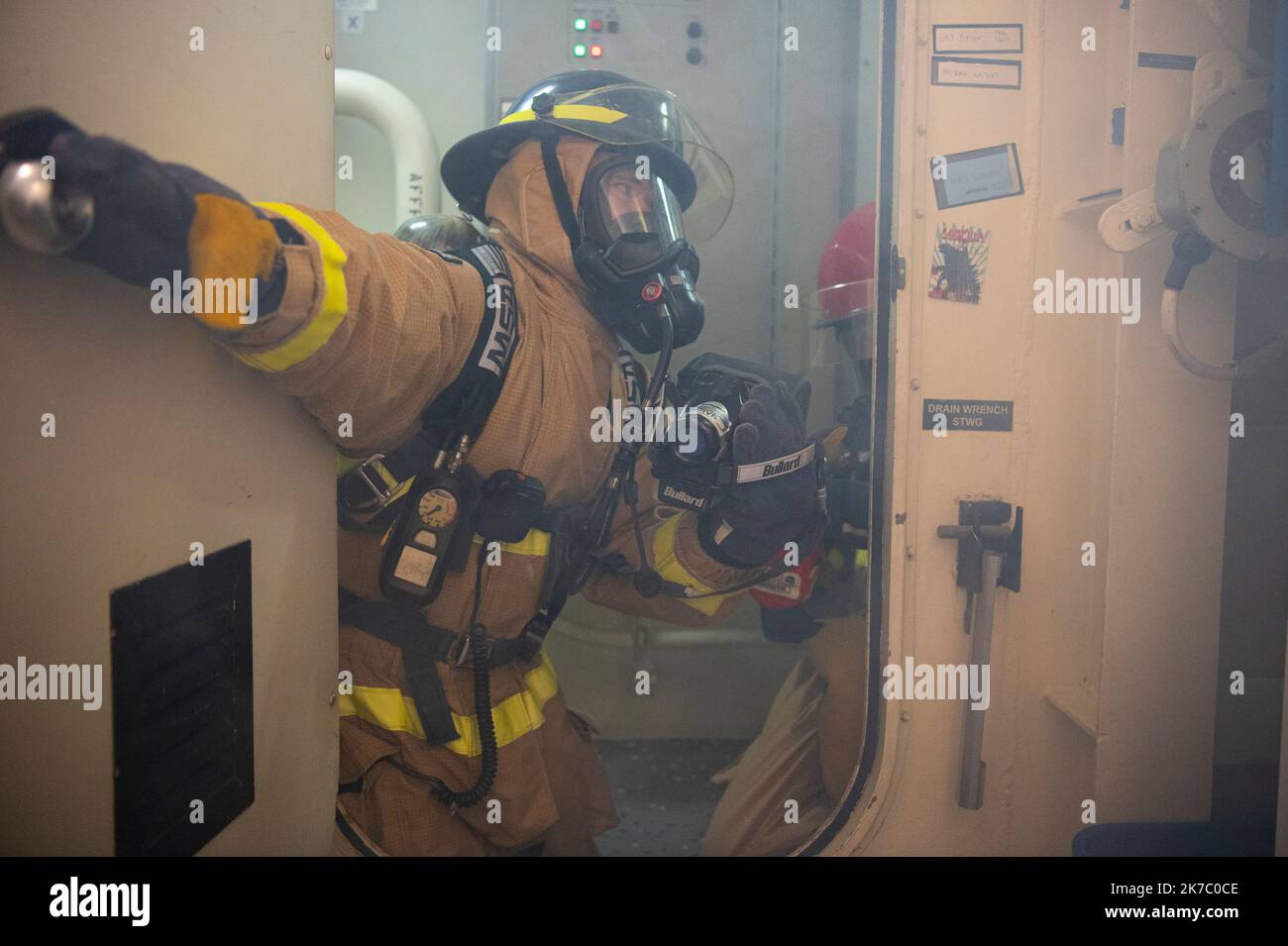 A USCGC Hamilton (WMSL 753) crew member fights a simulated fire during ...