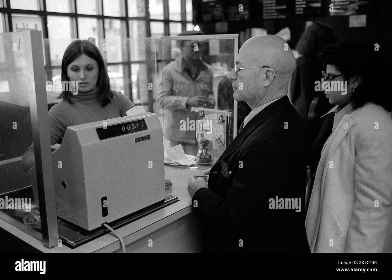 Arthur Rothstein, American photographer, at a store cashier in New York ...
