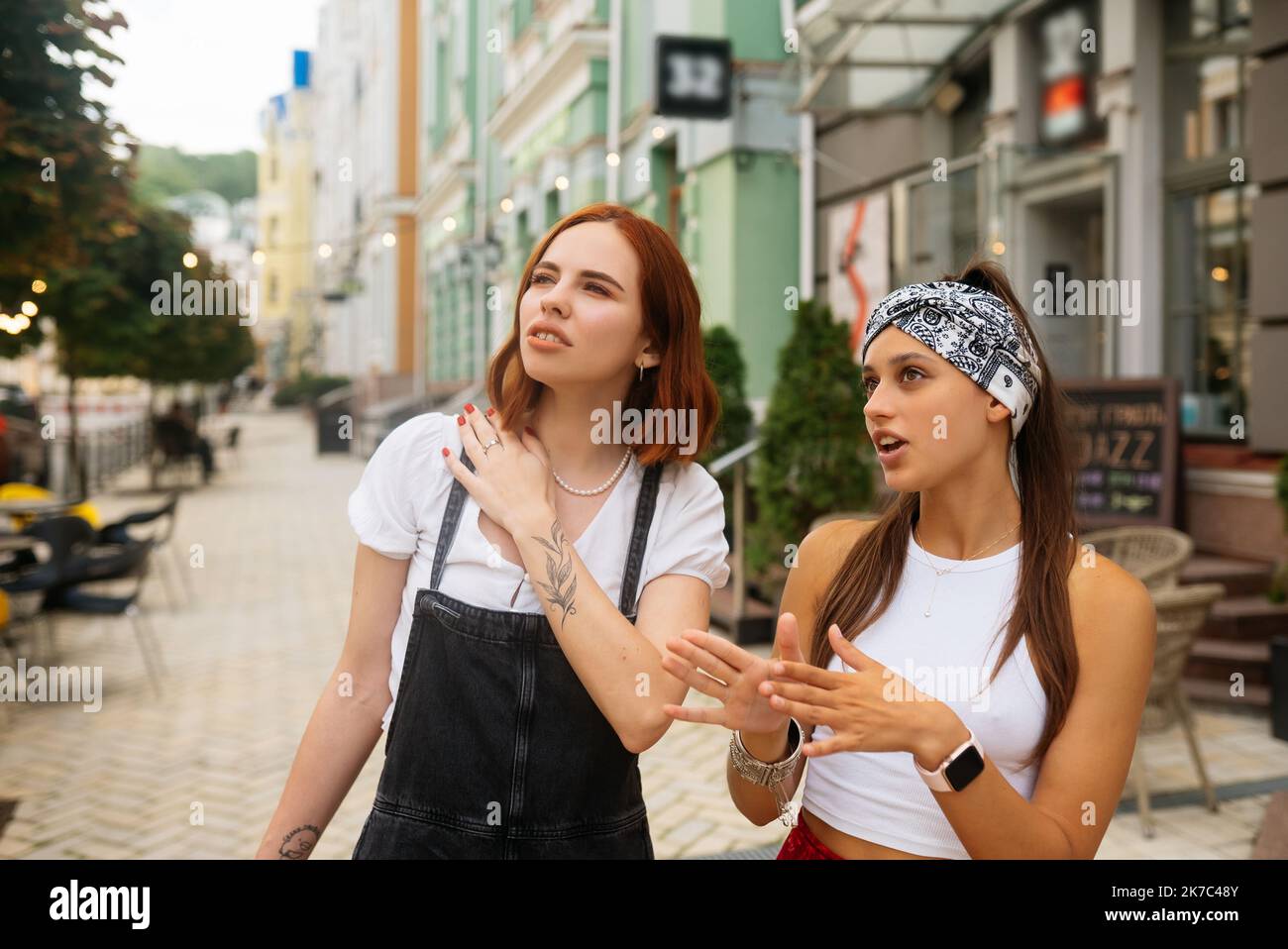 two young women walking outdoor having fun Stock Photo - Alamy