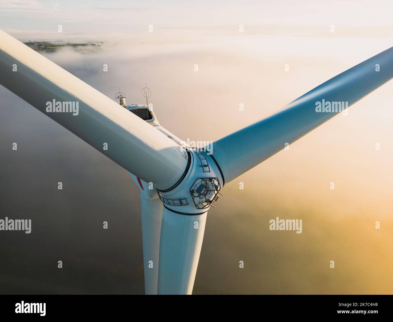 Close-up on the propellers of a wind turbine during a misty morning and ...