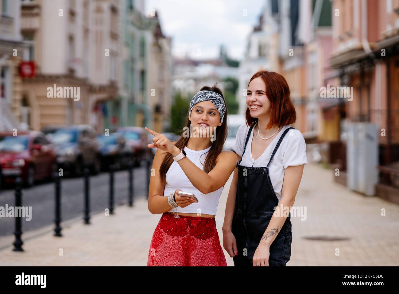 two young women walking outdoor having fun Stock Photo - Alamy
