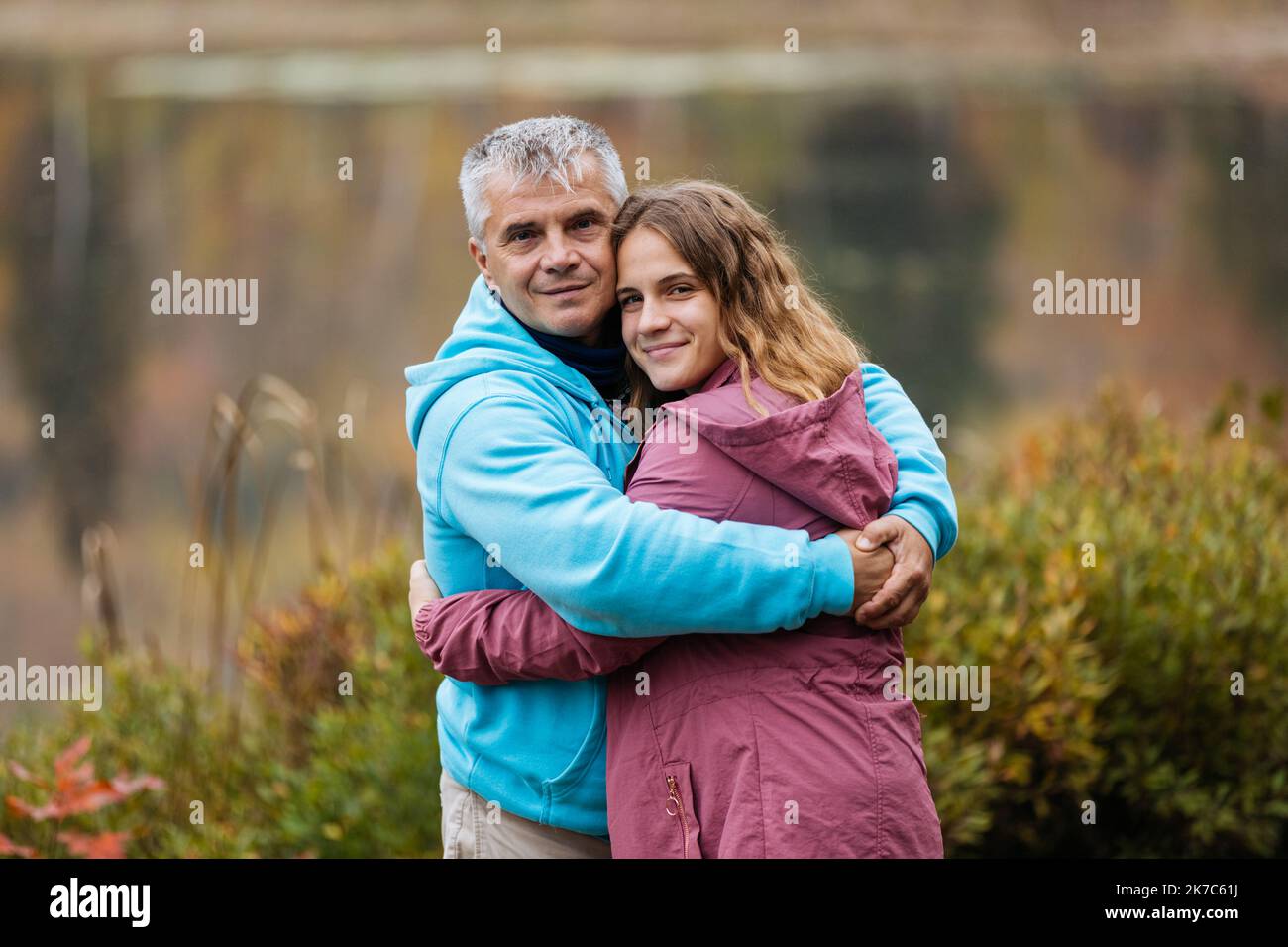 Middle aged father and daughter hug each other outdoors Stock Photo - Alamy