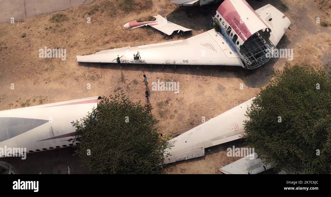 SCRAP, children playing on the wing of a decommissioned airplane, 2022 ...
