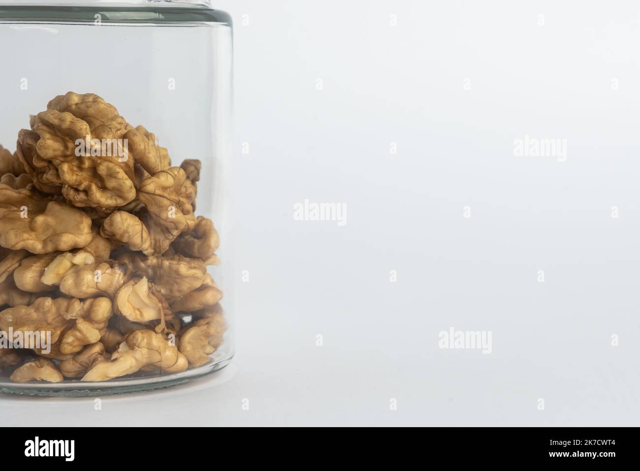 The walnut kernels in jar isolated on white background. close-up walnut ...