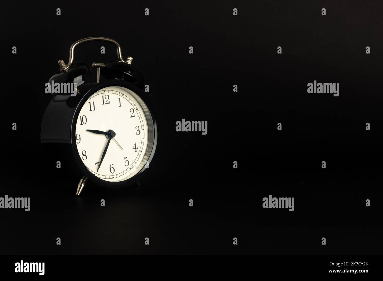 black vintage alarm clock isolated on black background, Time concept, 9 ...