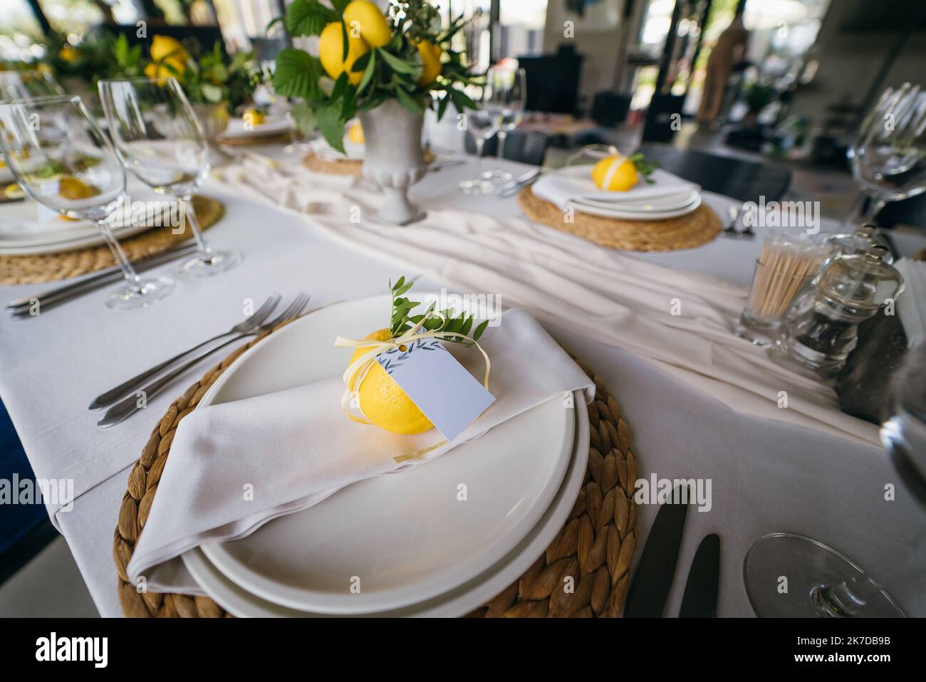 Festive table at the wedding party decorated with lemon arrangements ...