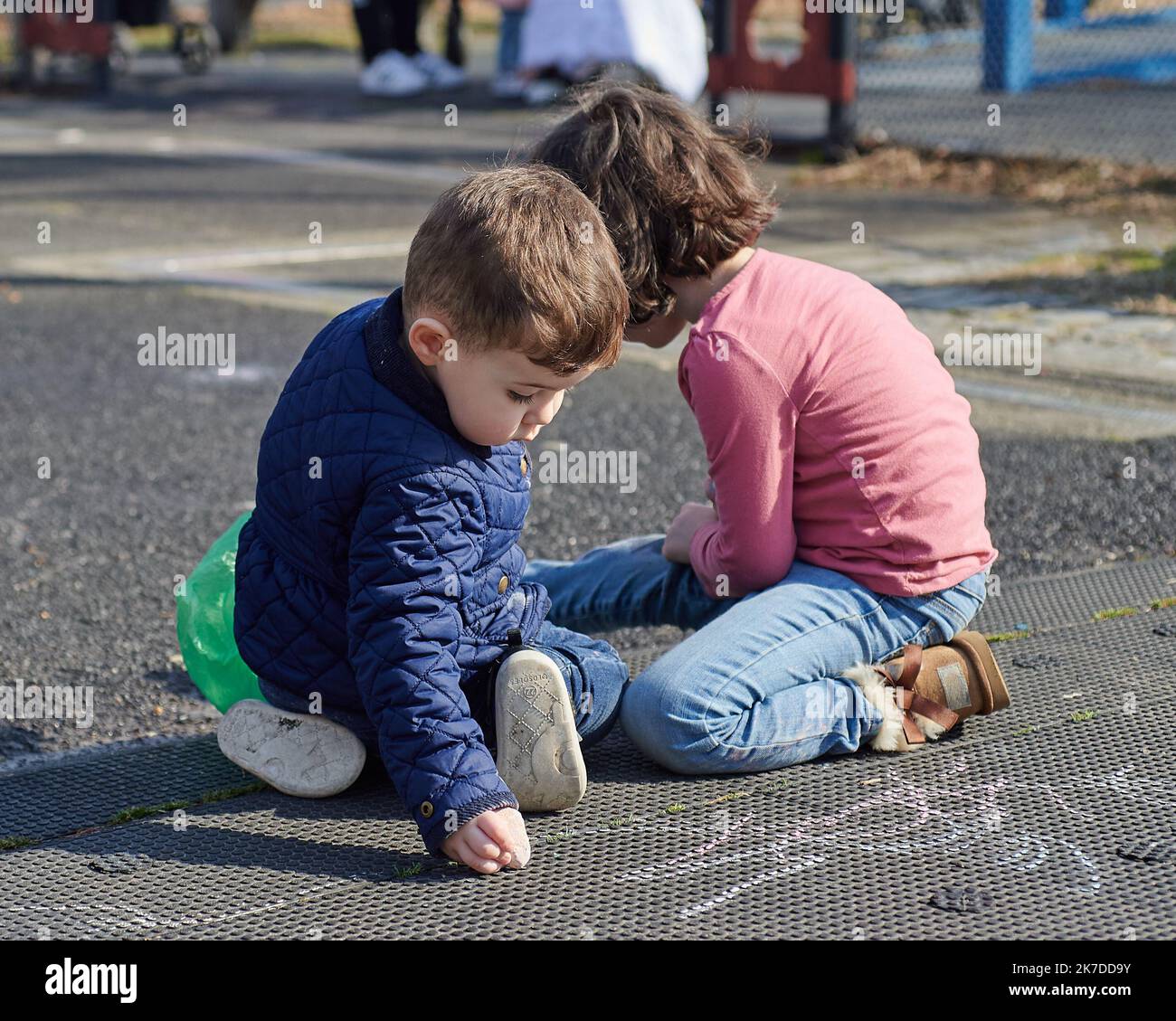 kids drawing in chalk on the playground Stock Photo - Alamy