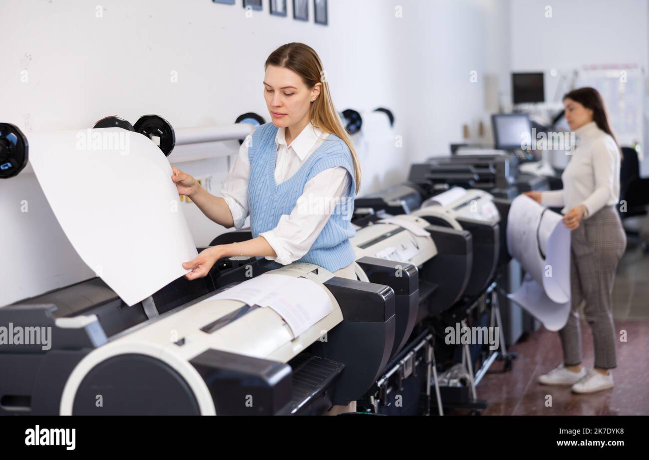 Print worker controlling printing process on modern offset machine in ...