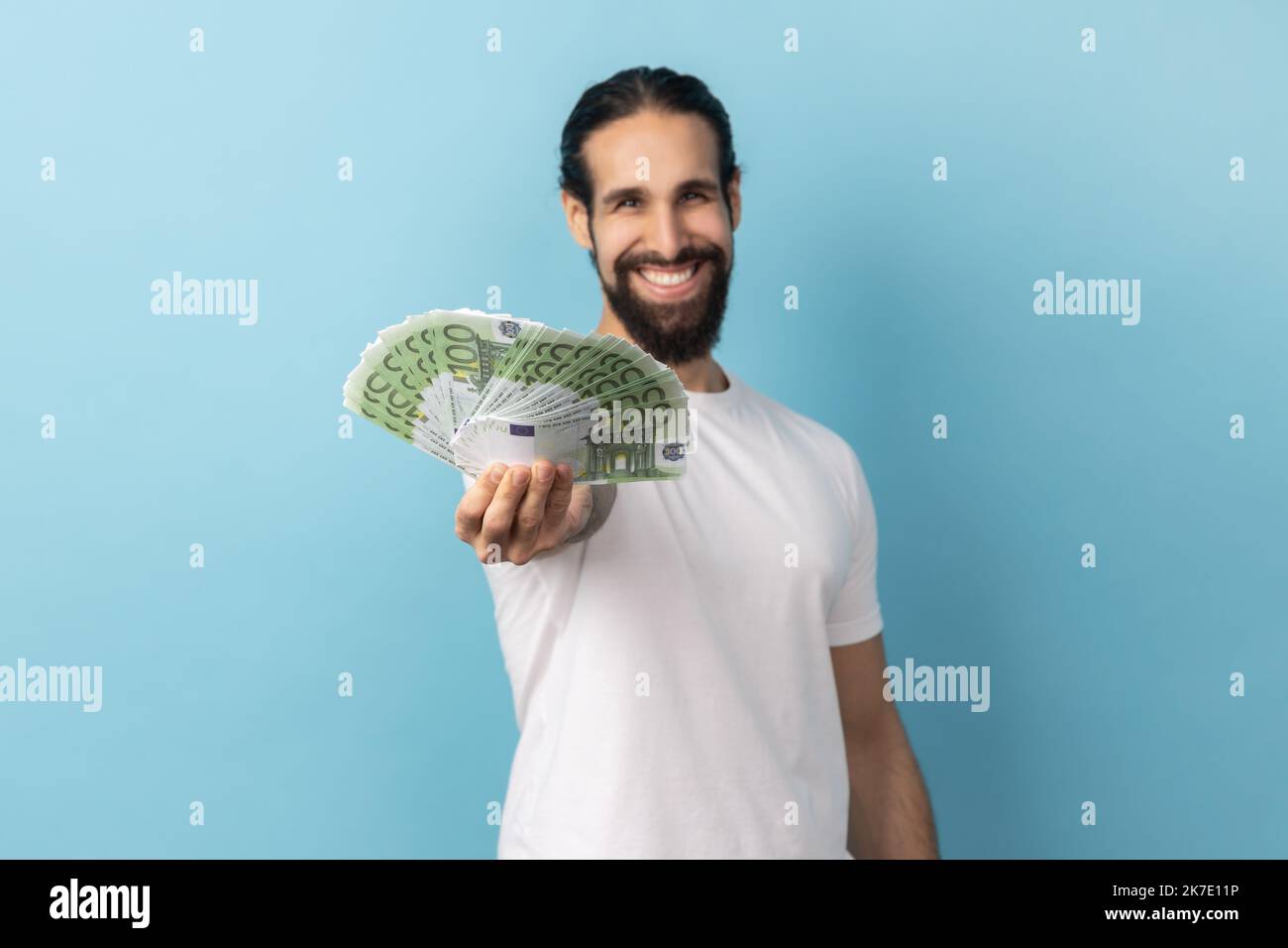 Portrait of smiling satisfied happy man with beard wearing white T ...
