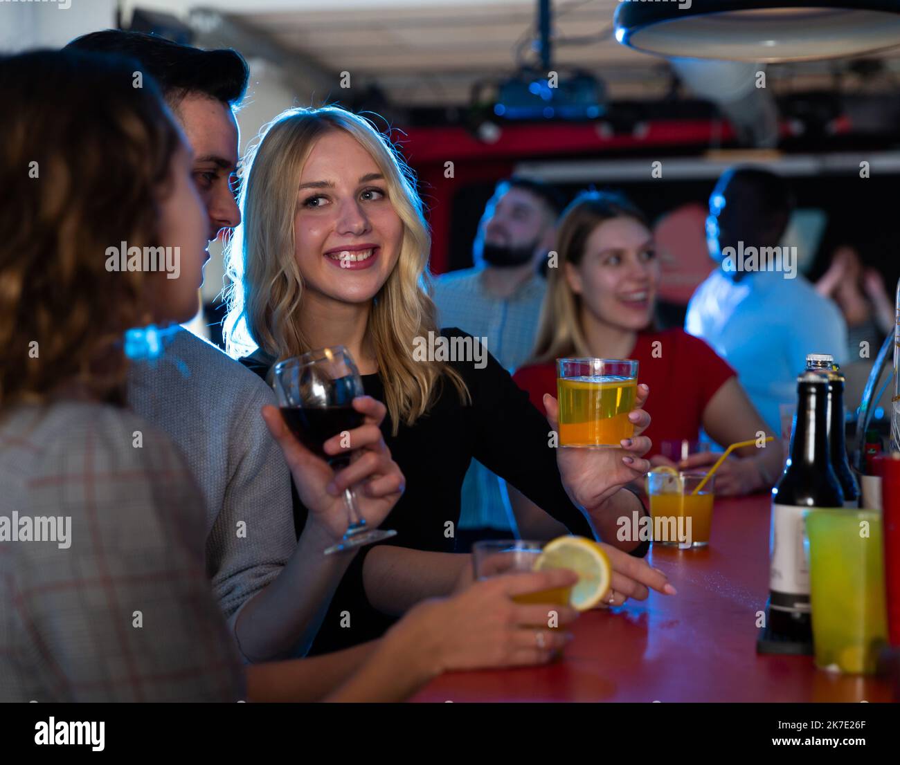 Friends drinking cocktails chatting together hi-res stock photography ...