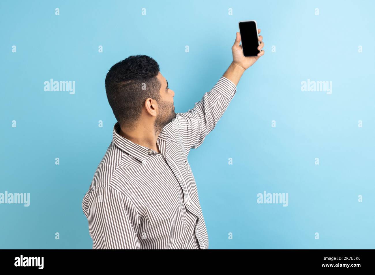 Back view of businessman talking video call, taking selfie on mobile ...