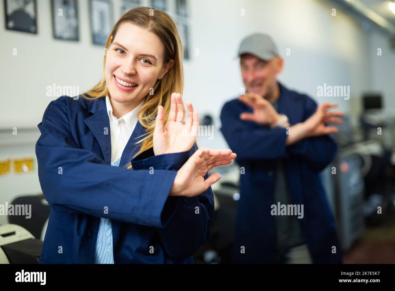 Engineer and office worker having fun dancing in print shop Stock Photo ...