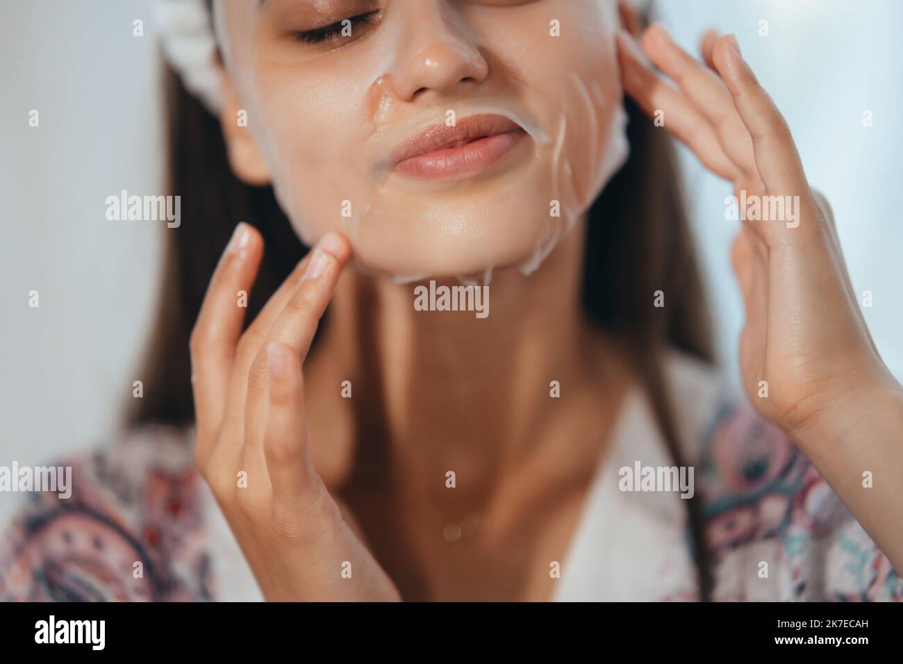 Beautiful model applying cosmetic cream treatment on her face Stock Photo - Alamy