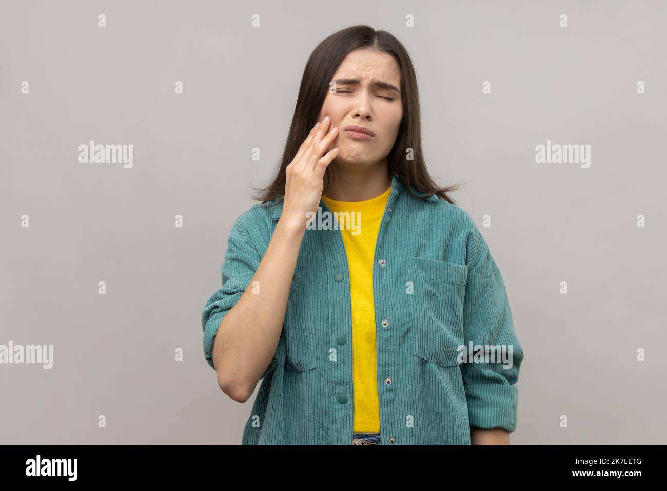 Unhealthy woman touching cheek, closing eyes with expression of ...