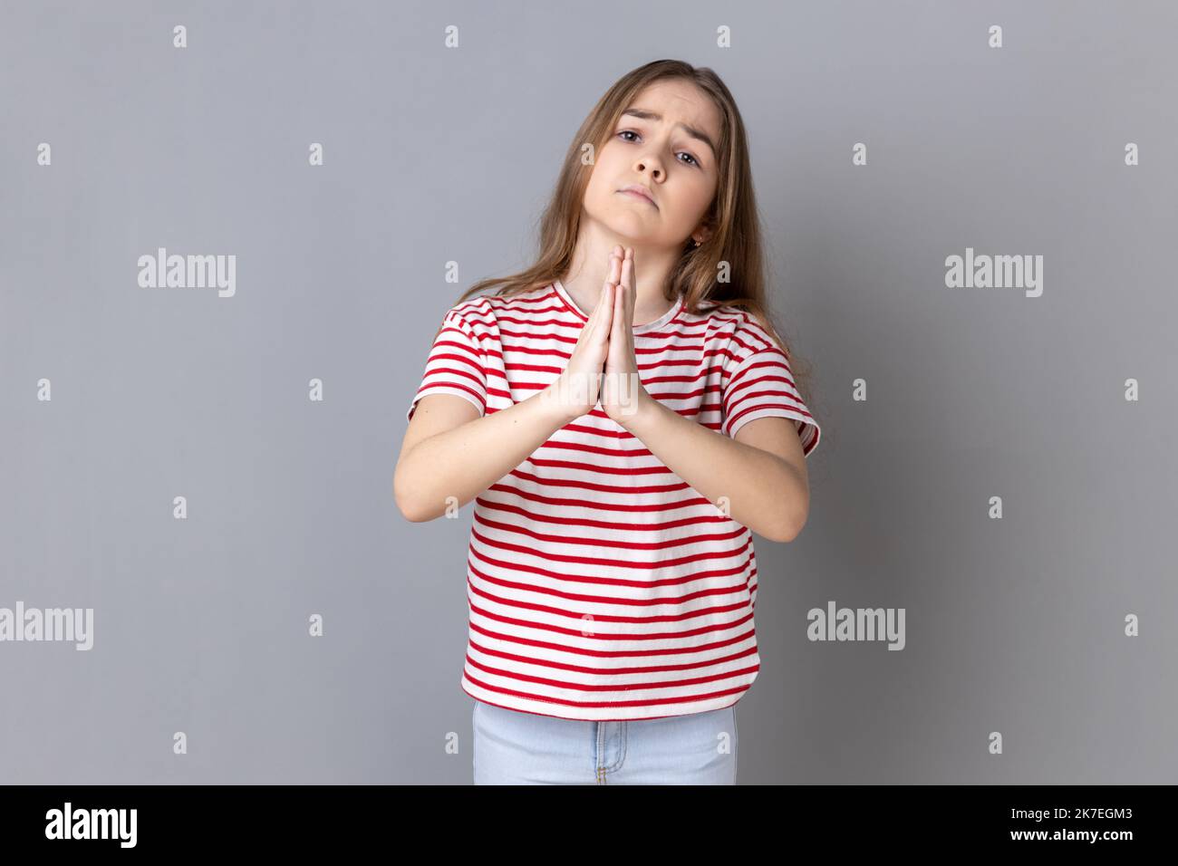 Please help me or forgive. Portrait of worry sad little girl wearing ...
