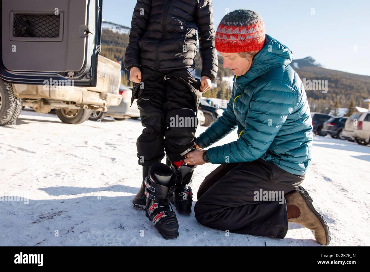 Child helping put on jacket hi-res stock photography and images - Alamy