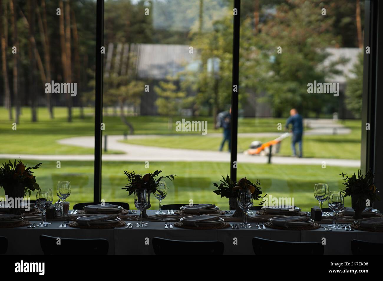 View of the lawn through the window of the banquet hall Stock Photo - Alamy