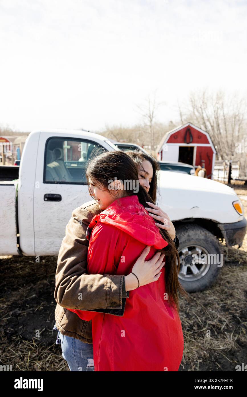 Happy mother and daughter farmers hugging on sunny farm Stock Photo - Alamy