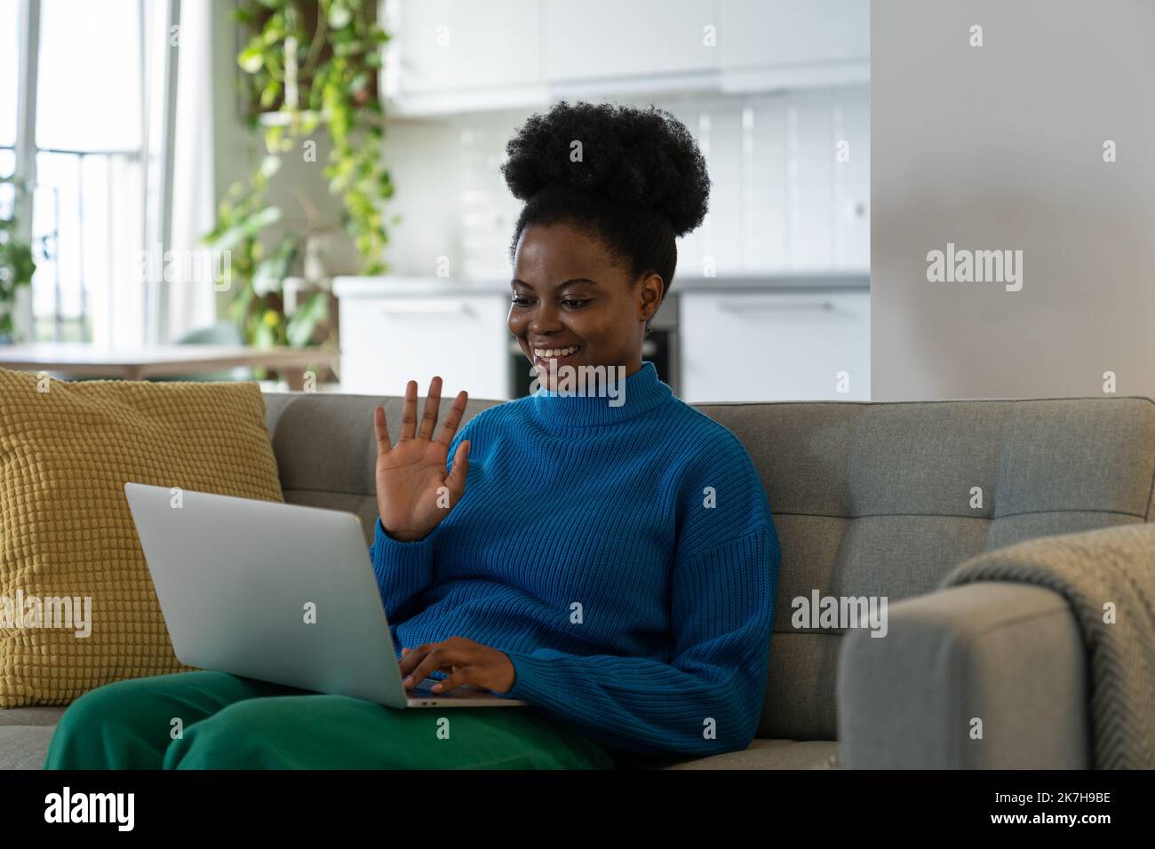 Cheerful young African American woman with smile making video call sits ...