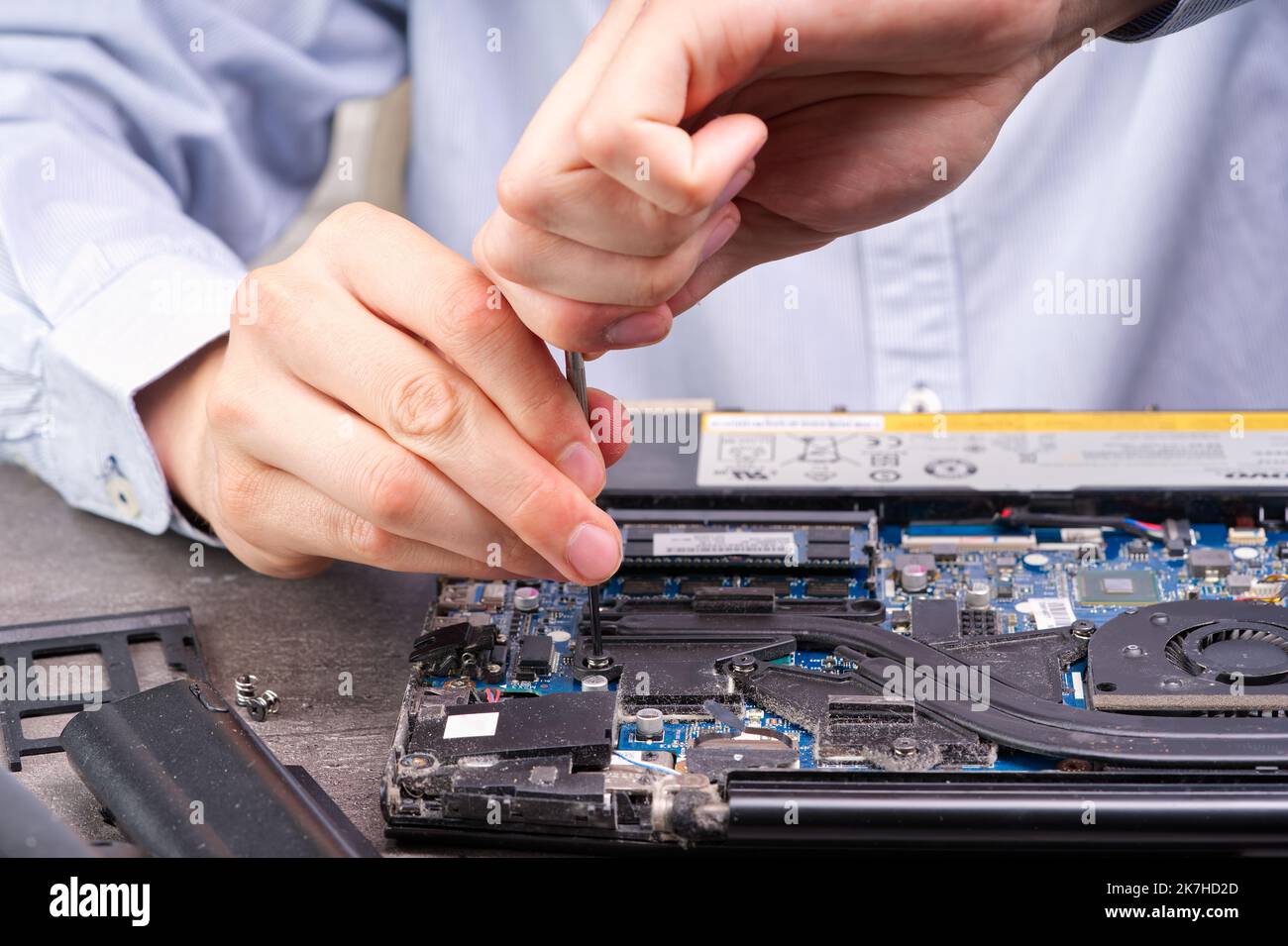 Man disassembles a laptop. Computer service and repair concept. Laptop ...
