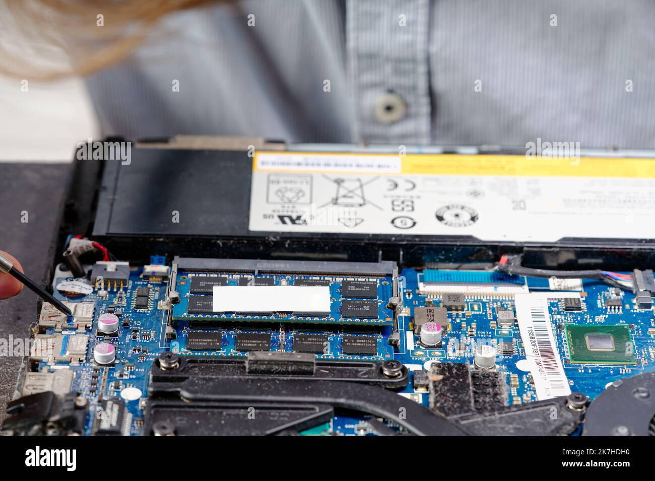 Man disassembles a laptop. Computer service and repair concept. Laptop disassembling in repair ...