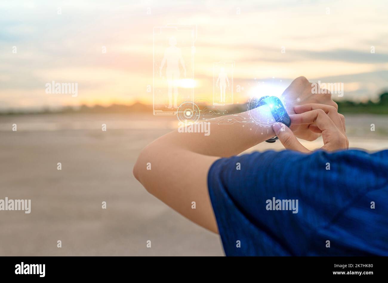 Young Asian woman touching smart band after running in the morning ...