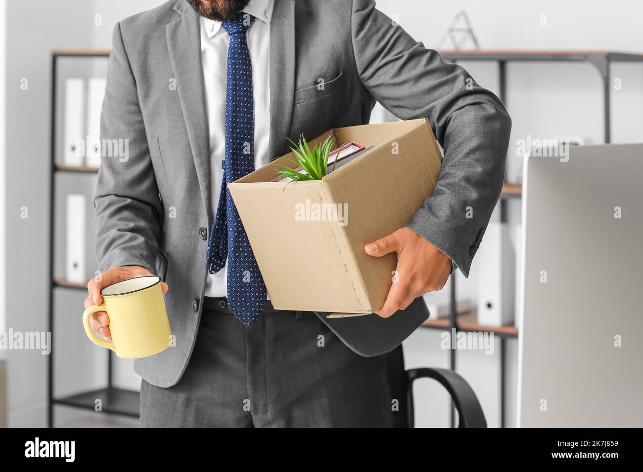 Fired young man holding box with his stuff in office Stock Photo - Alamy