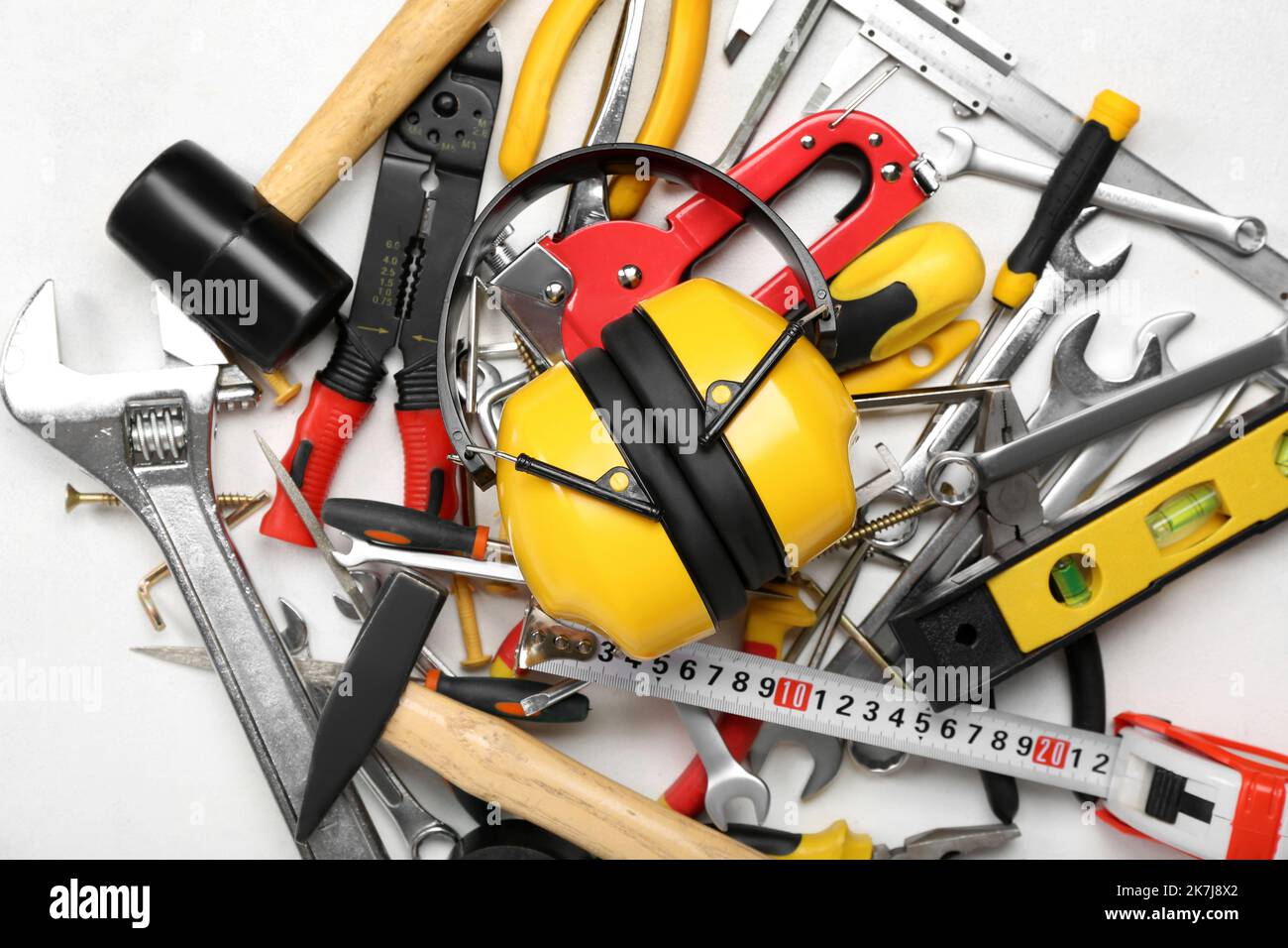 Hearing protectors with builder's tools on white background Stock Photo ...