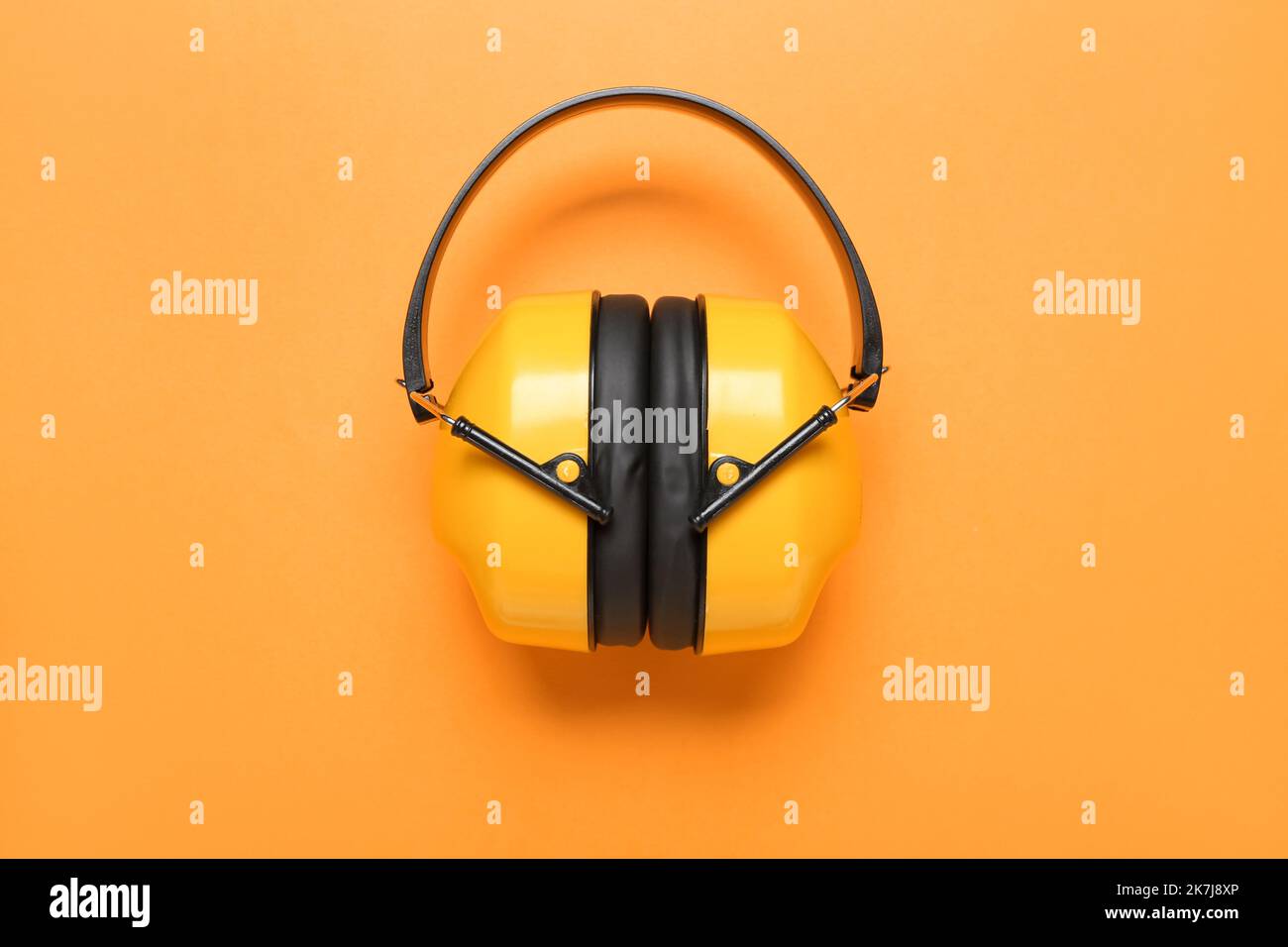 Hearing protectors on color background Stock Photo - Alamy