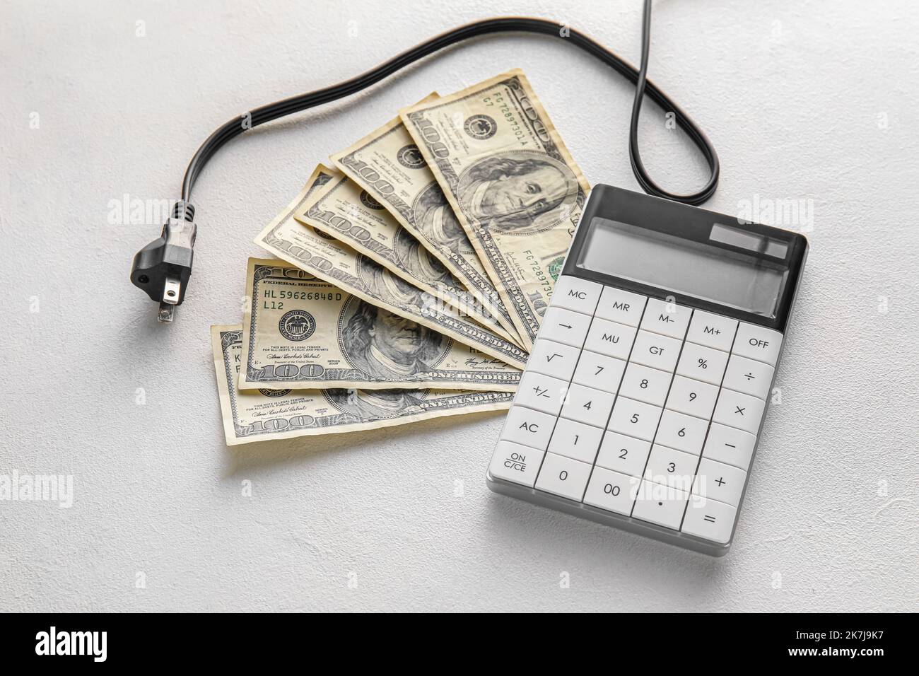 Dollar banknotes with plug and calculator on white background. Heating ...
