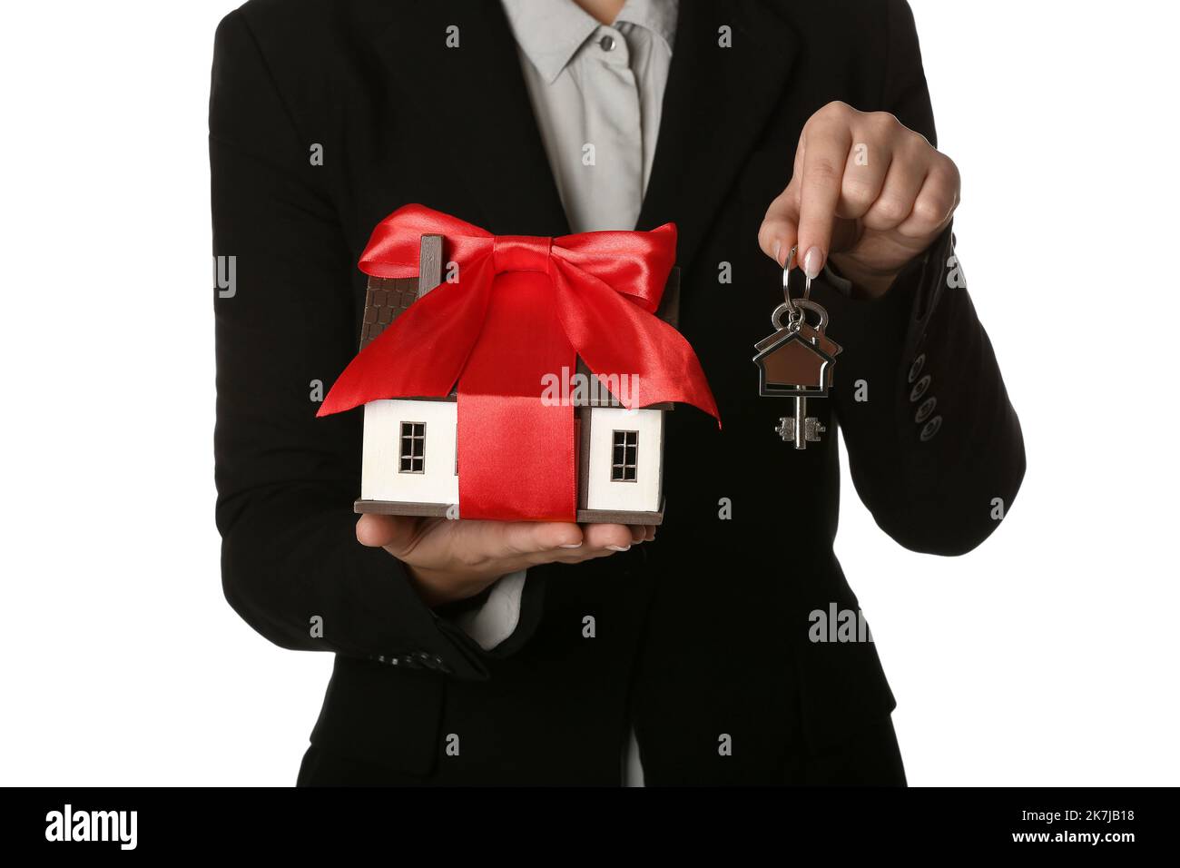 Real estate agent with house model and key on white background, closeup ...