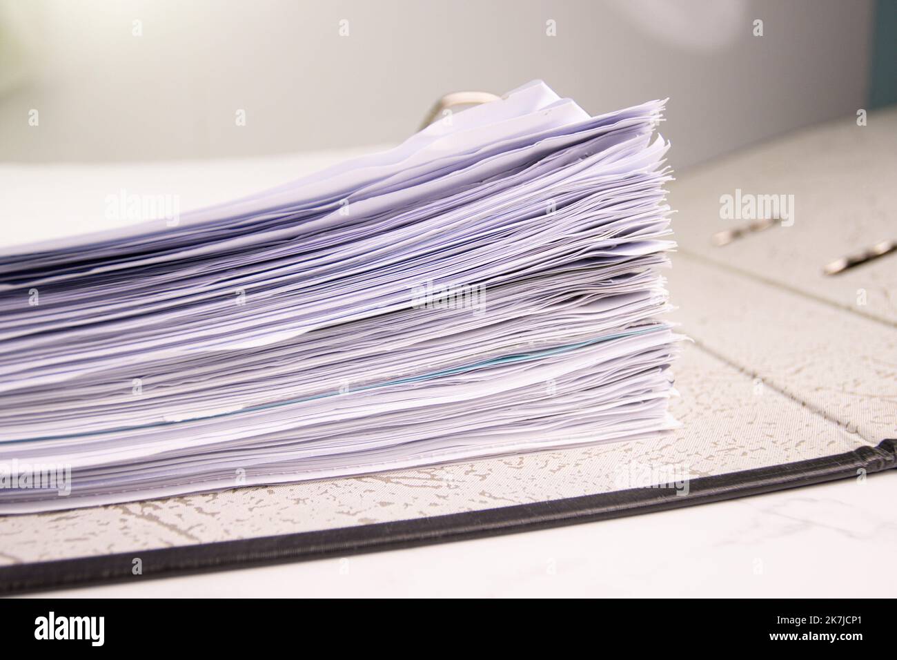 white paper stack in folder file for a business contract, income ...