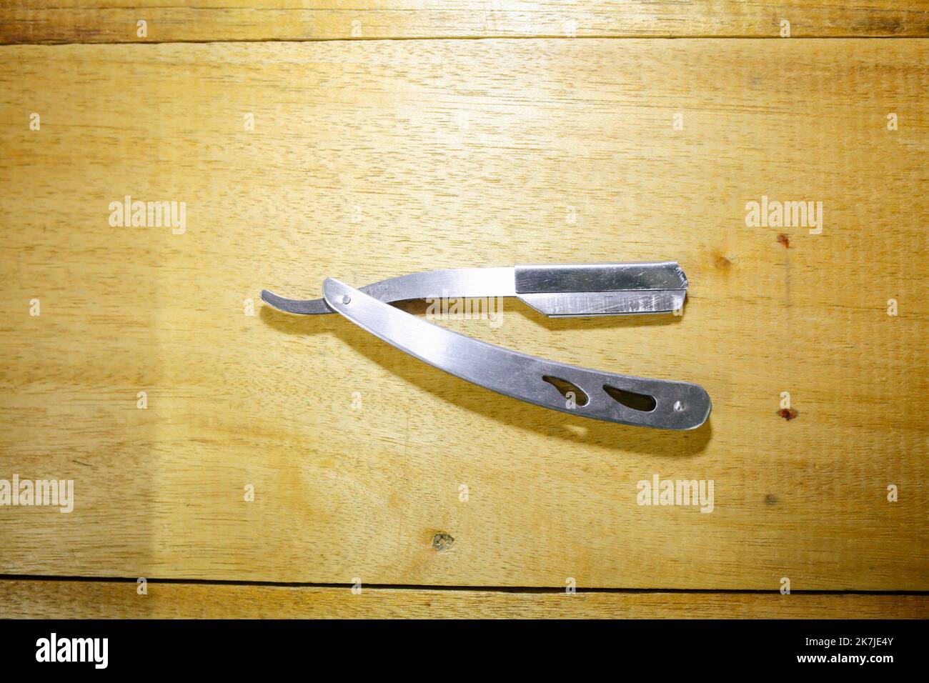 Open old dangerous razor on a wooden background. isolated, blade Stock ...