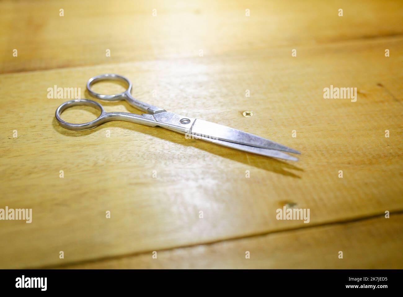 Barber scissors wooden background Stock Photo - Alamy