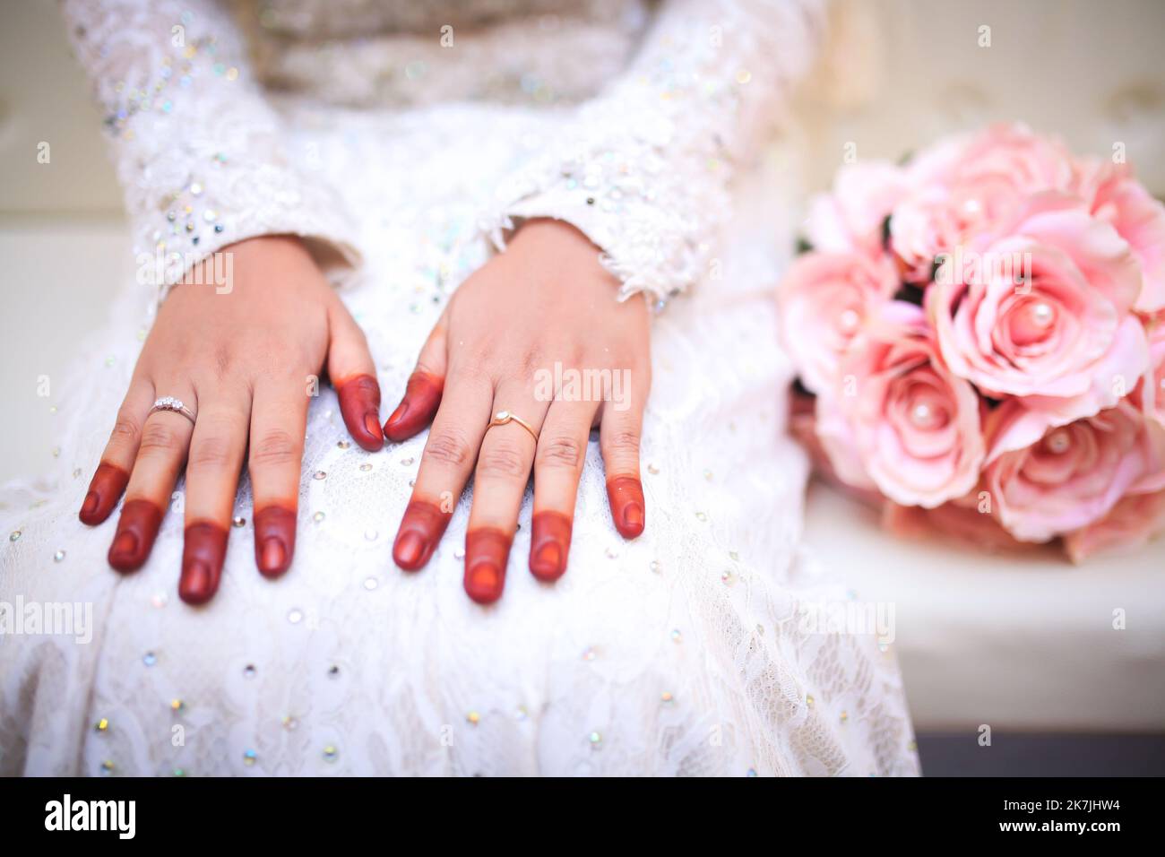 Wedding ring in brides' hands Stock Photo - Alamy