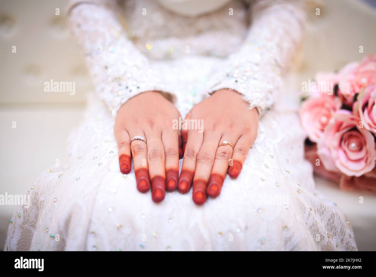 Wedding ring in brides' hands Stock Photo - Alamy