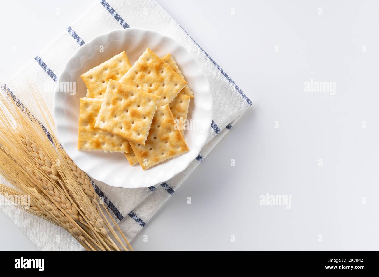 Lots of crackers in a plate placed on a white background with space ...