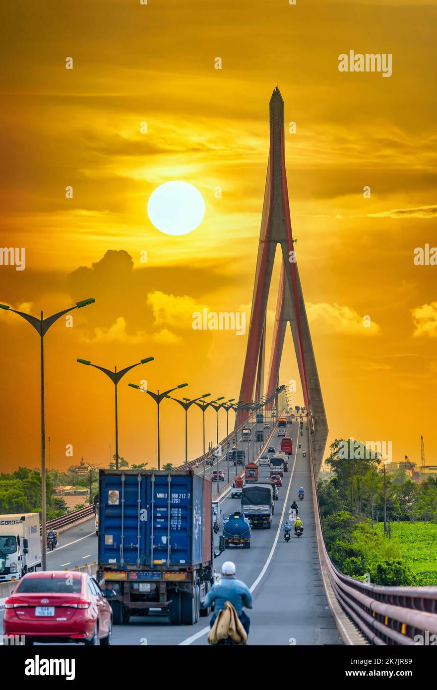 Heavy traffic on Can Tho bridge at sunset sky. Can Tho bridge is famous ...