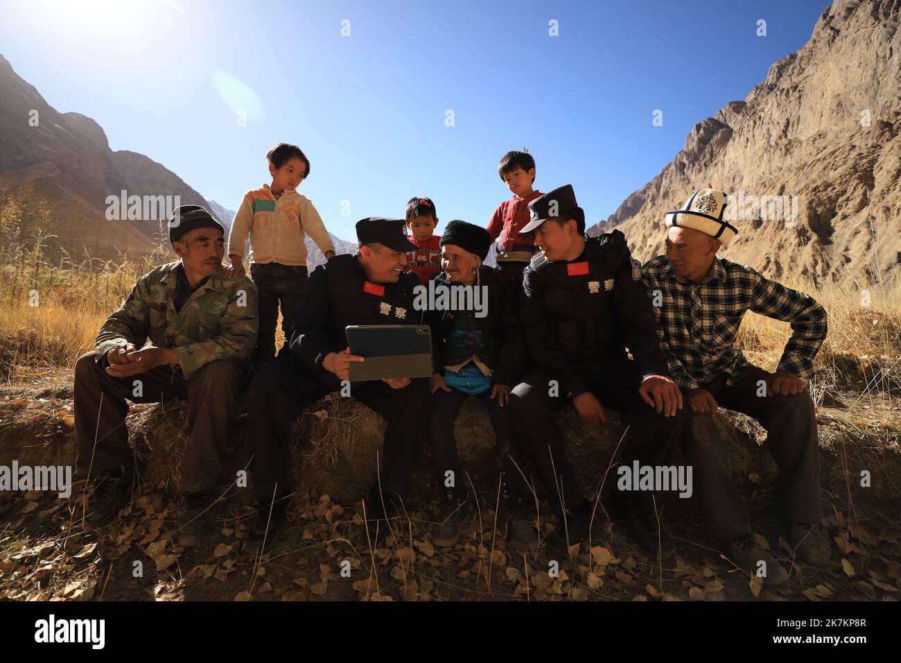 HOTAN, CHINA - OCTOBER 17, 2022 - Police officers and residents watch ...