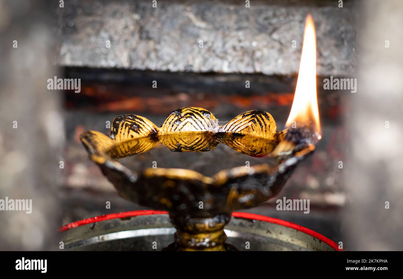 A flame burns in a bowl of owl in a small temple in Hong Kong Stock ...