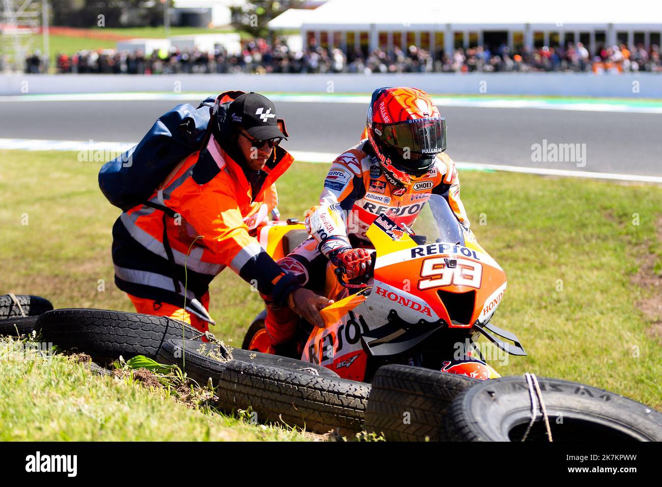 Phillip Island, Australia, 16 October, 2022. A marshal pushes Marc Marquez of Spain on the ...