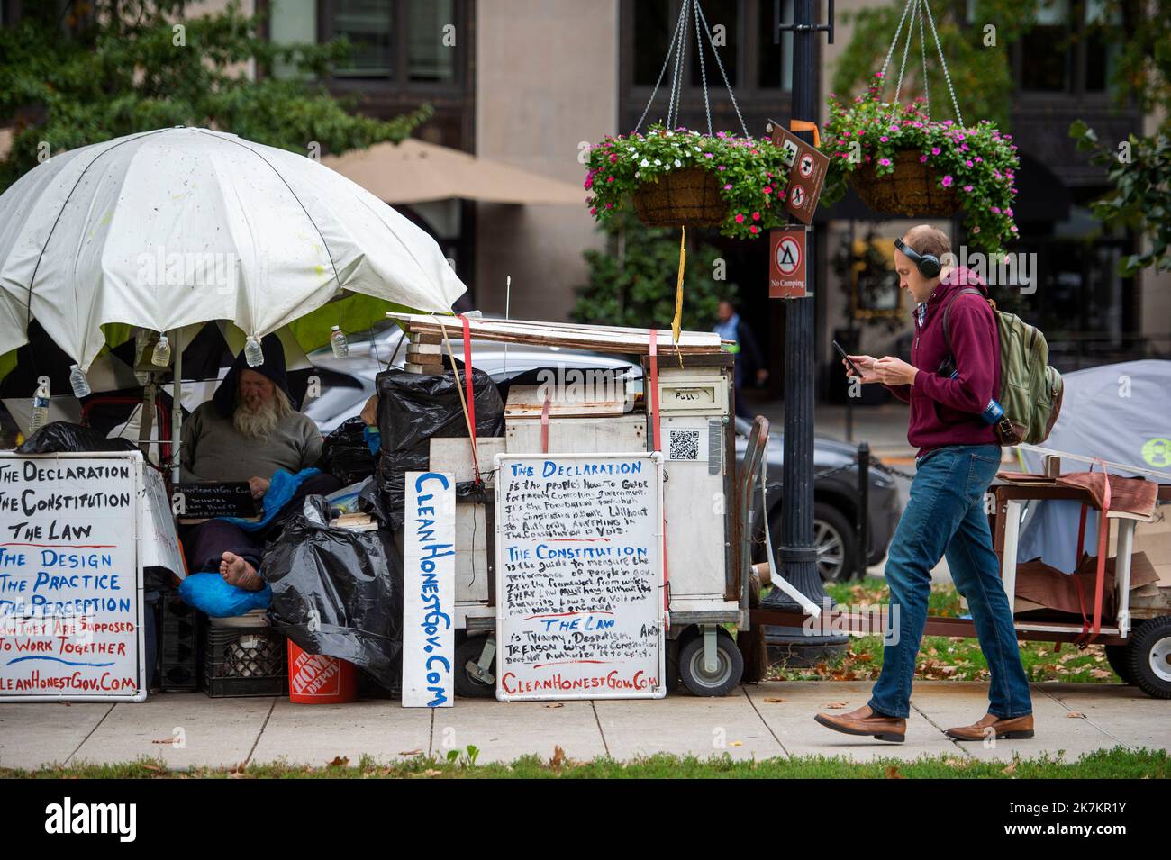 A man passes by the makeshift shelter of former US Marine Daniel ...