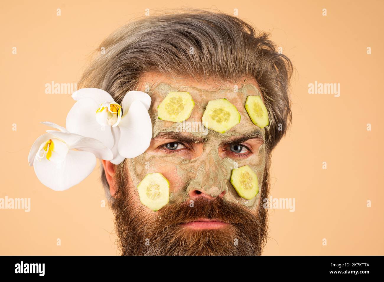 Close up face with clay mask and cucumber slices. Spa, dermatology ...