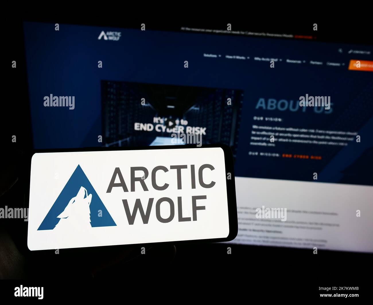 Person holding mobile phone with logo of cybersecurity company Arctic ...