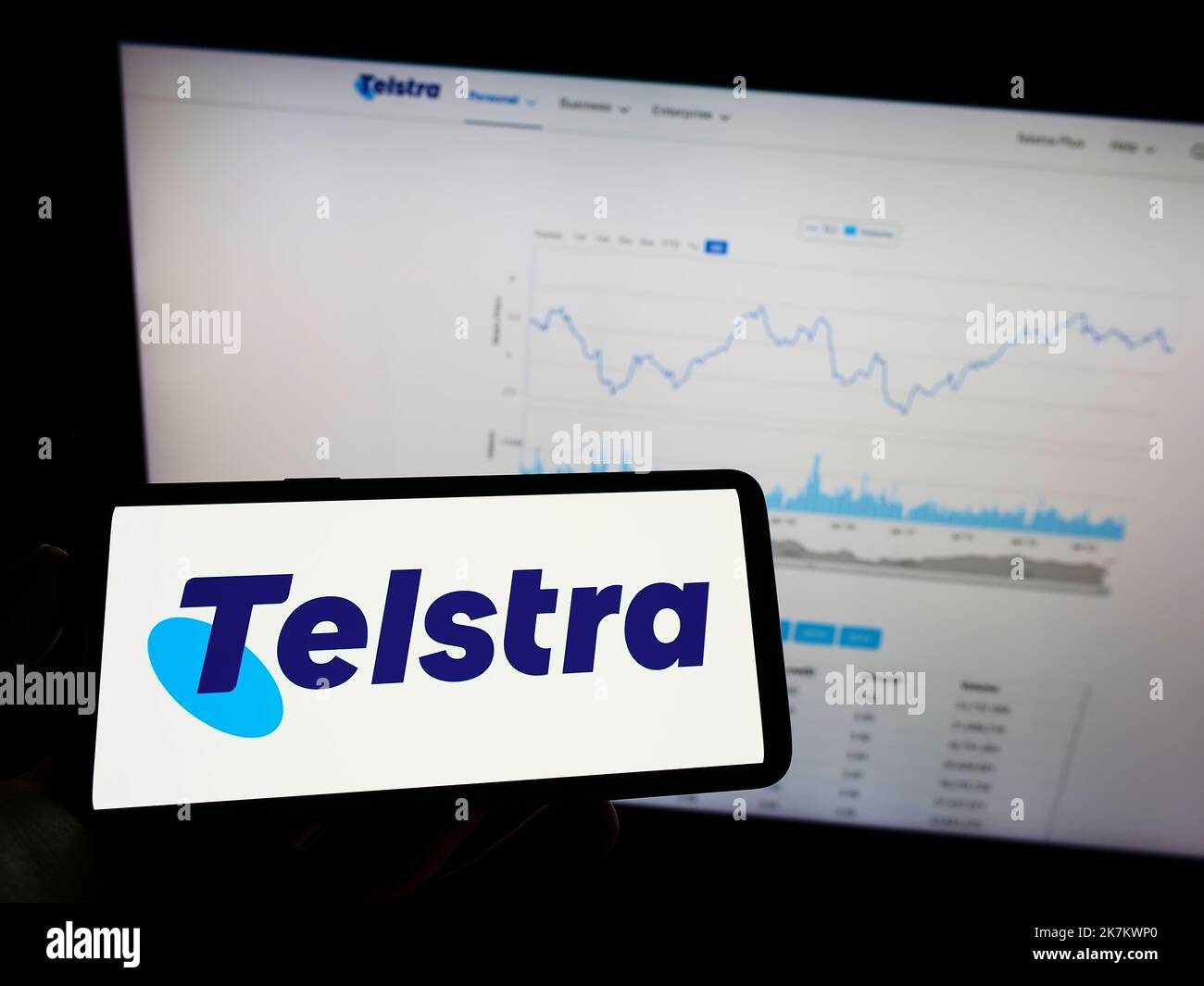Person holding cellphone with logo of Australian company Telstra ...